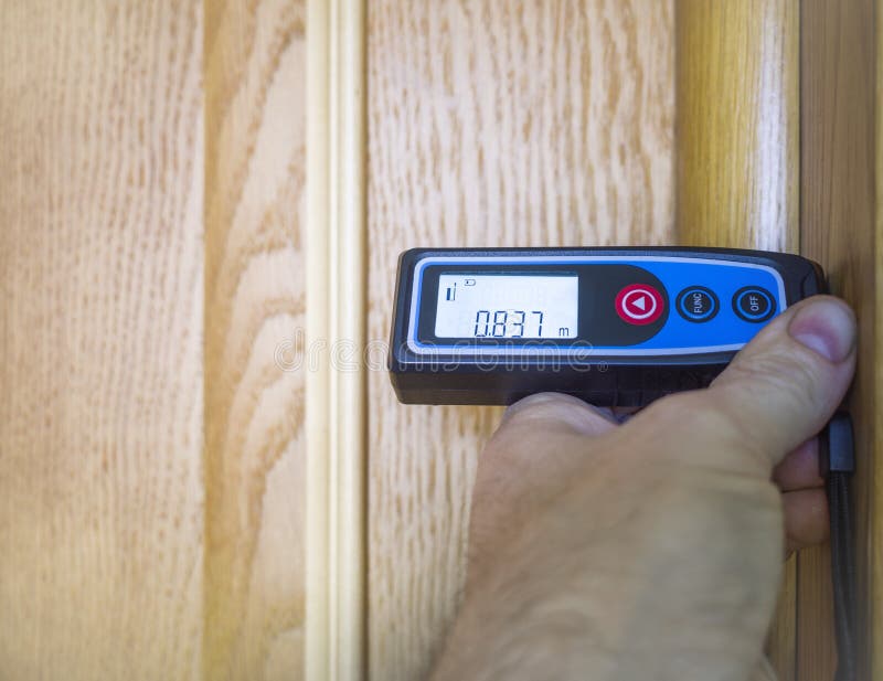 Measuring the Doorway with a Laser Tape Measure. Stock Image - Image of ...