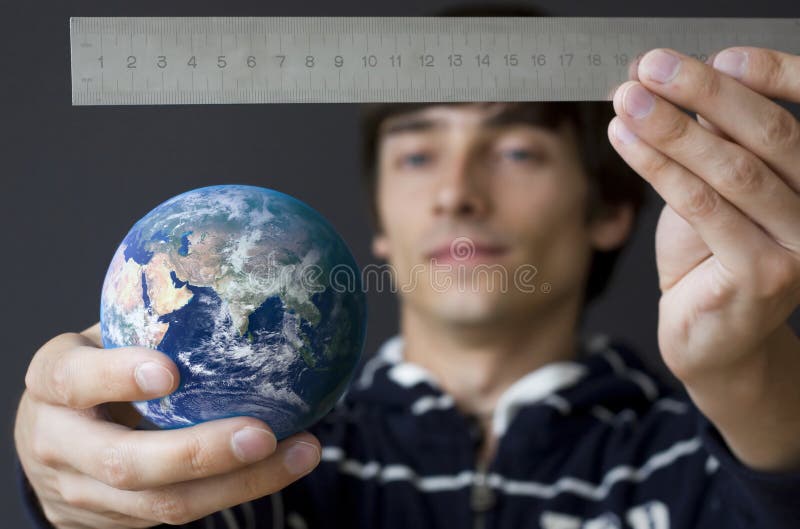 Measuring the earth stock photo. Image of inch, hold - 10419862