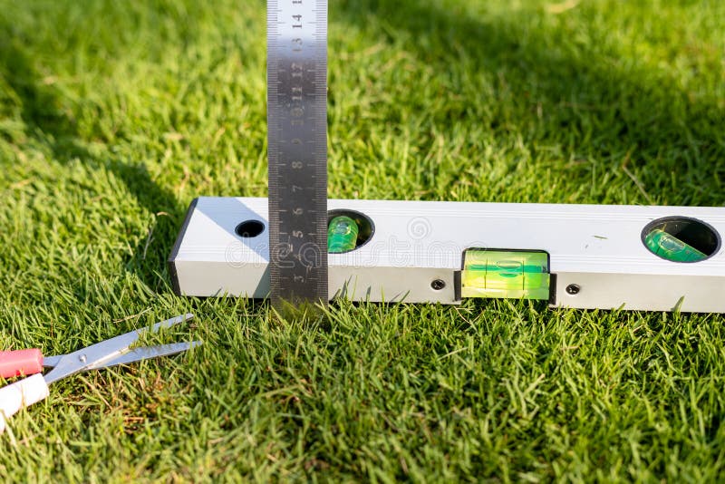 Cutting the Grass with Scissors and Using the Level Tool To Level the ...