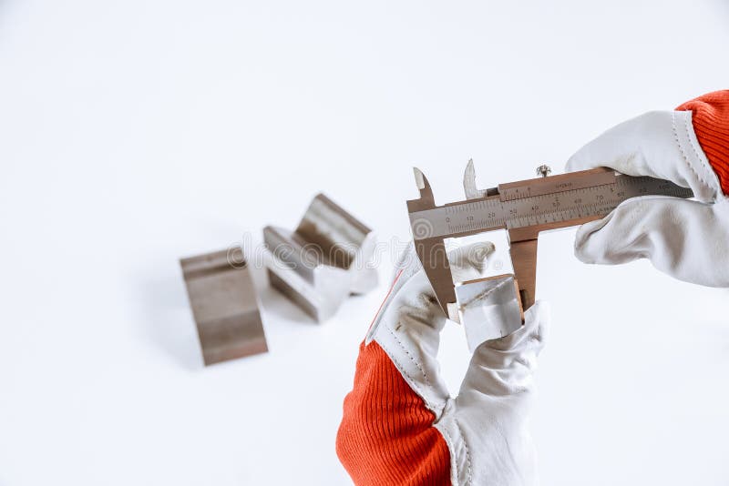 Measuring the Length of a Metal Piece with a Caliper on a White ...