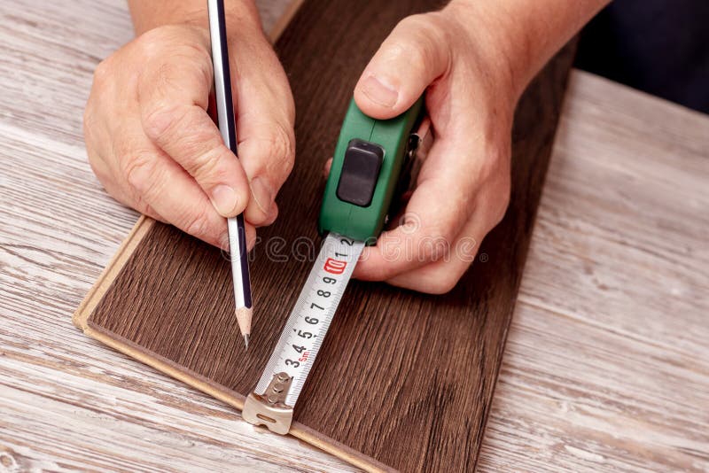 Measuring and Marking the Board with a Tape Measure Stock Image - Image ...