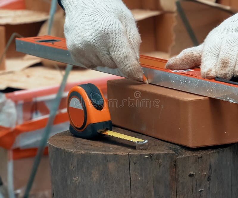 Measuring and Marking Bricks during the Construction of House Stock ...
