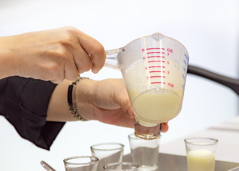 Measuring Out Milk in a Measuring Jug for Cooking or Test Stock Photo ...