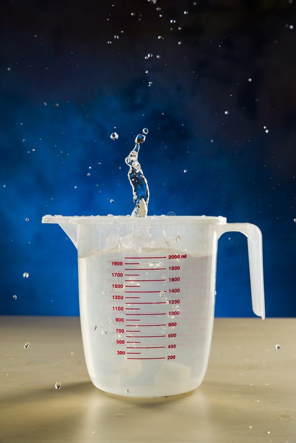 Measuring Plastic Container with a Splash Stock Image - Image of ...