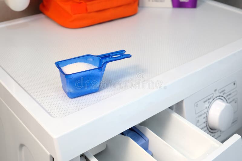 A Measuring Plastic Container with Washing Powder and Open Container ...