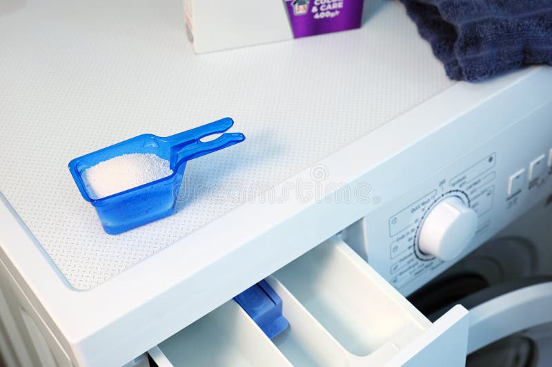 A Measuring Plastic Container with Washing Powder and Open Container ...