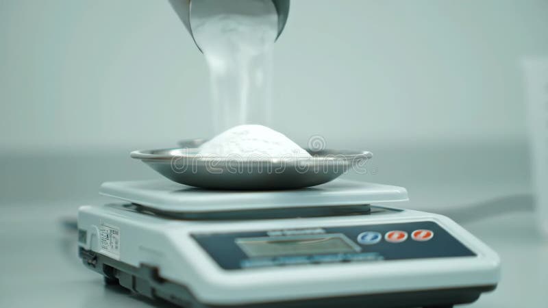 Measuring and Pouring White Powder into a Bowl on a Digital Scale in a ...