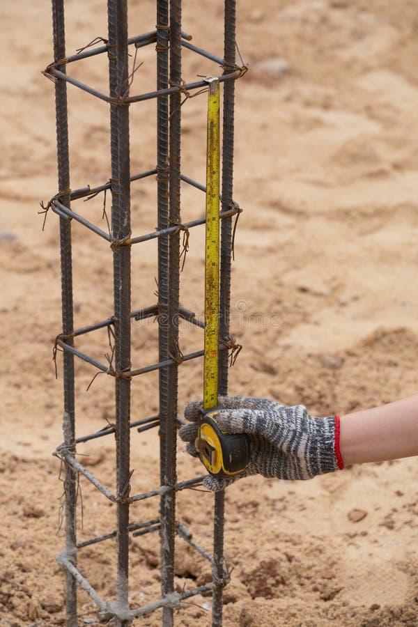 Measuring Steel Rod at Construction Site with Tape Measure Stock Image ...