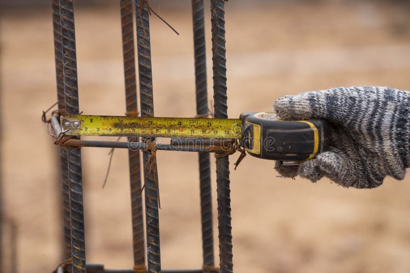 Measuring Steel Rod at Construction Site with Tape Measure Stock Image ...