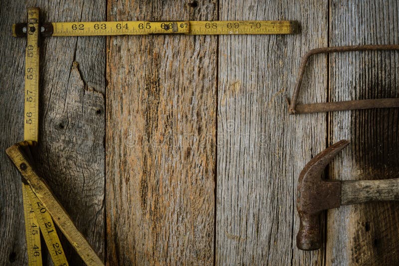 Measuring Tape Hammer and Saw on Rustic Old Wood Stock Photo - Image of ...