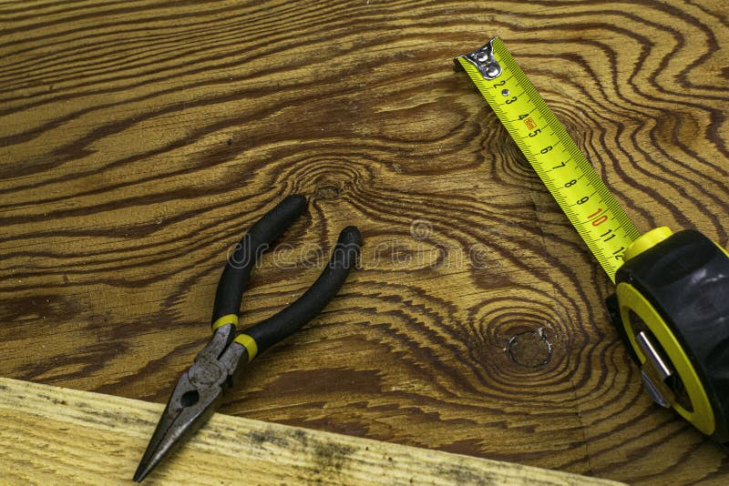 Measuring Tape Measure Board and Pliers on the Workbench Stock Image ...