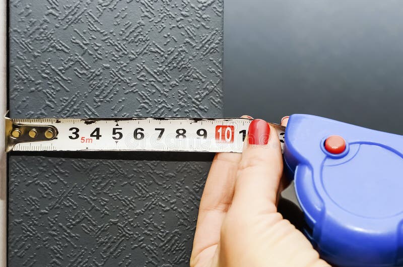 Measuring with a Tape Measure of a Wall, Renovation Concept Stock Image ...