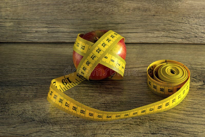 Measuring Tape Wrapped Around A Red Apple Stock Image - Image of around ...