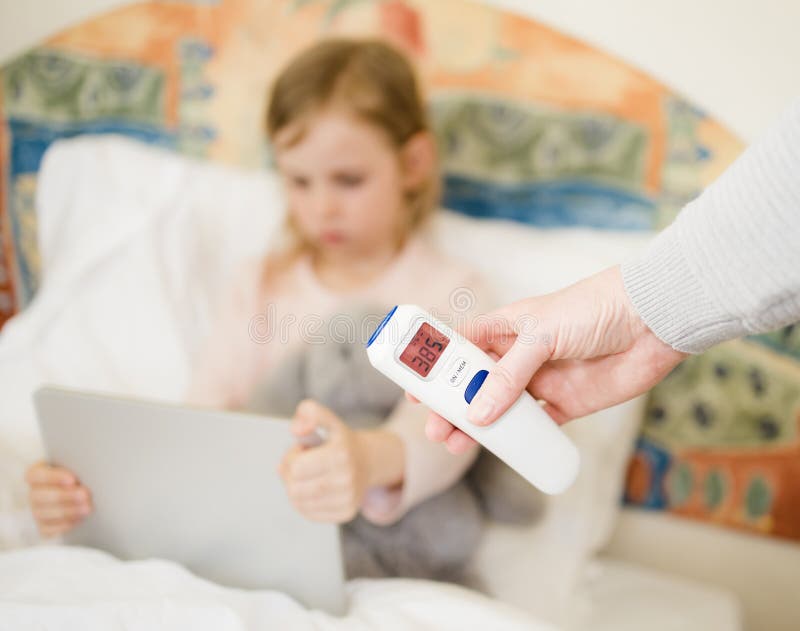 Measuring Temperature of Child with Infrared Thermometer Stock Photo ...