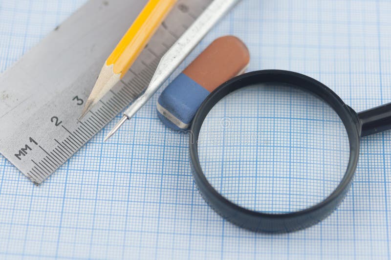 Measuring Tools Above Blue Graph Paper Stock Image - Image of equipment ...