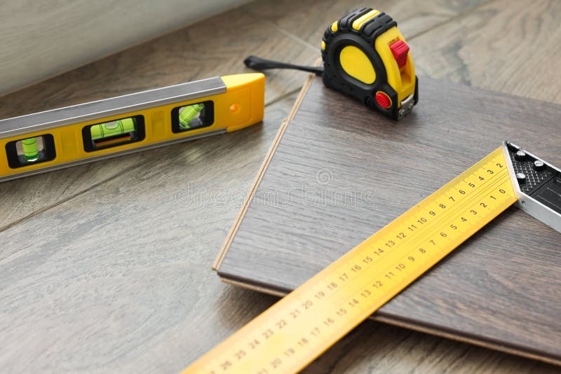 Measuring Tools and Laminate Flooring Pieces on Wooden Surface, Closeup ...