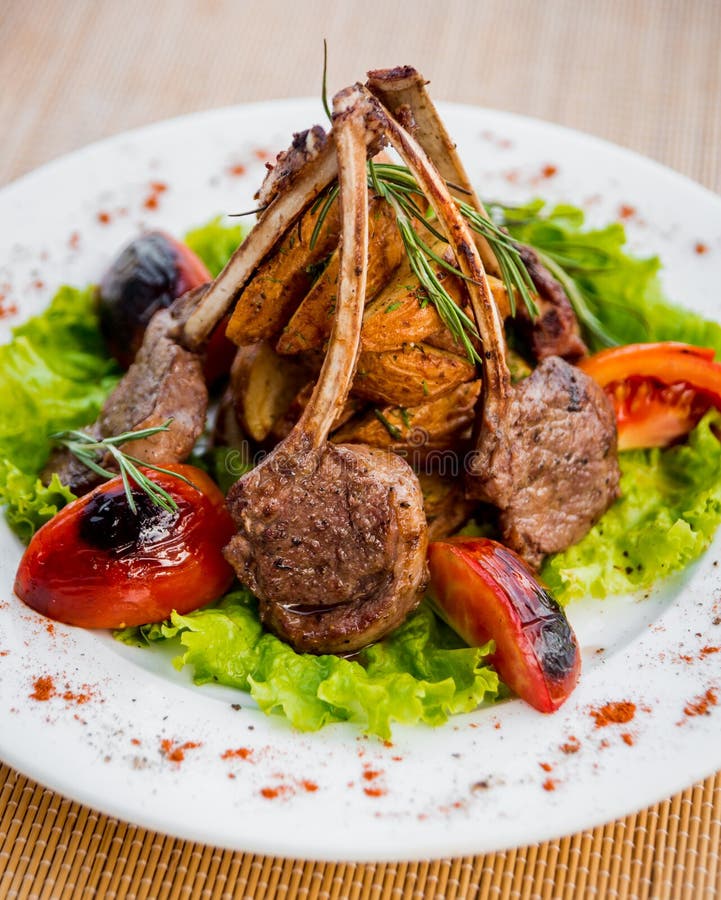 Meat on the Bone with Vegetables on a White Plate. Restaurant. Stock ...