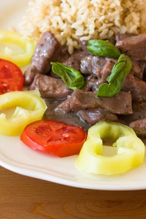 Meat with Brown Rice and Garnish Stock Image - Image of paprika, chef ...