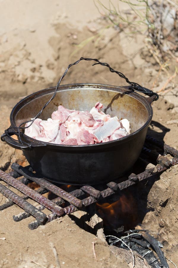 Meat in a cauldron on fire stock image. Image of meat - 101633223