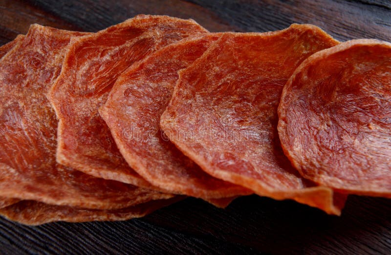 Meat Chips are Laid Out in a Row. Thin Pieces of Dried Meat Stock Photo ...