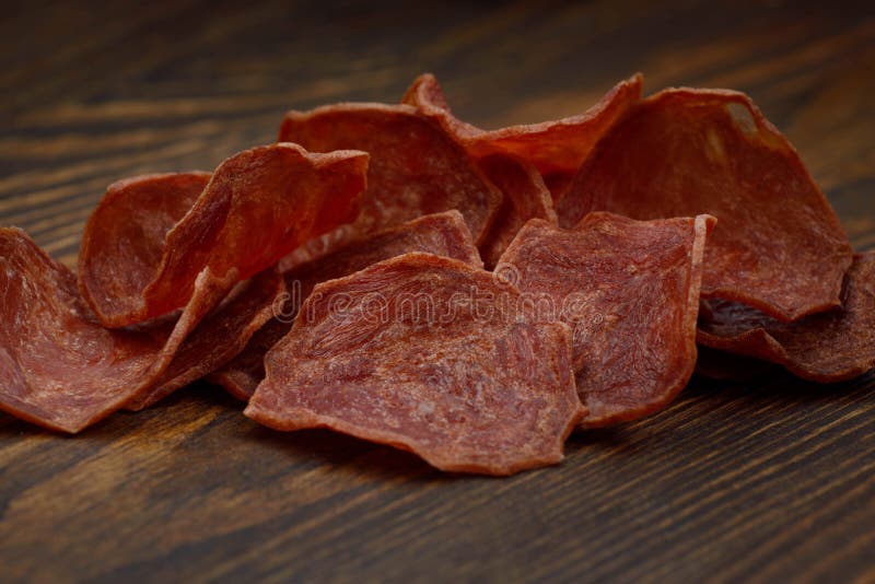 Meat Chips on a Wooden Board. Beautiful Placer of Thin Slices of Dried ...