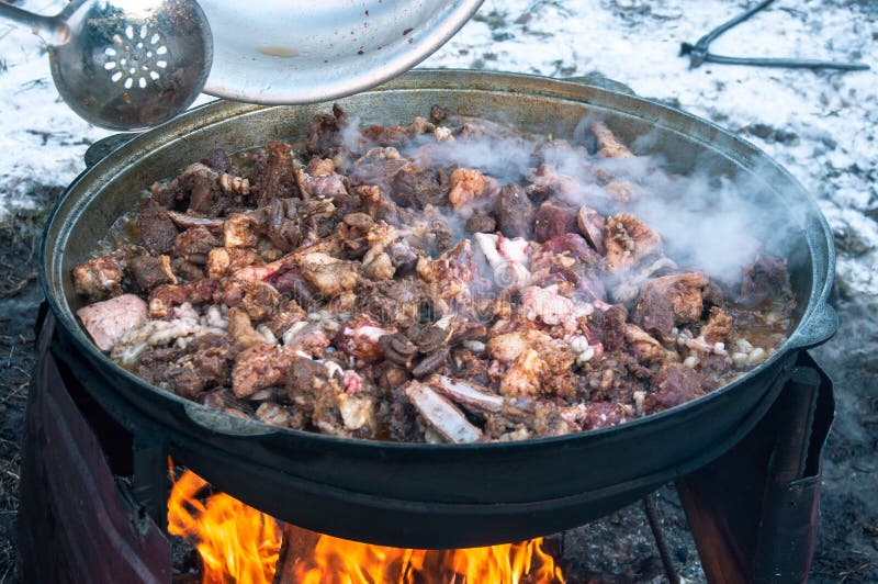 Cooking Meat on Fire in a Large Cauldron. a Traditional Dish Stock ...