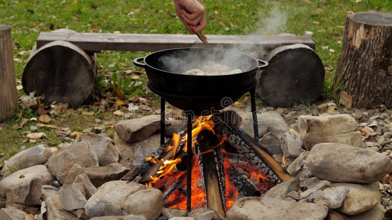 Cooking Over a Fire in a Large Cast-iron Cauldron during the Absence of ...