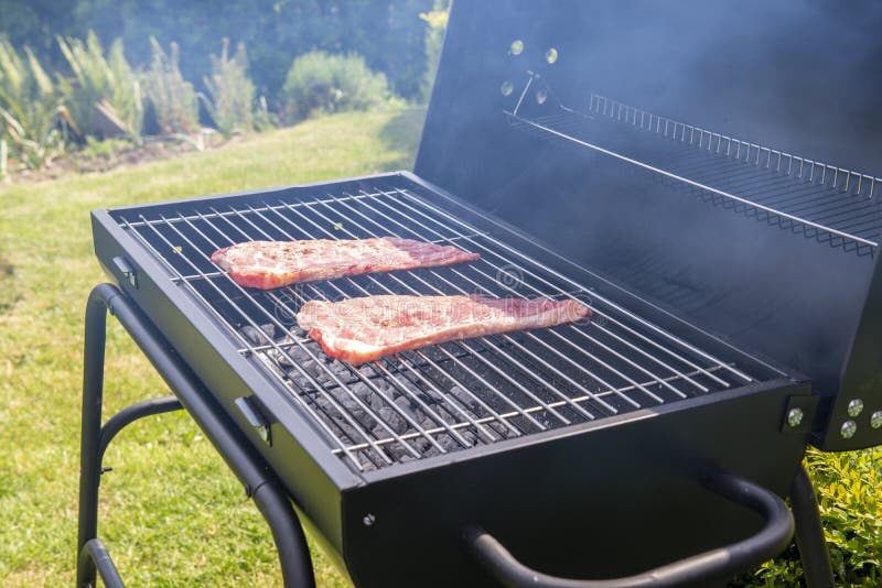 Meat cooking on a BBQ stock image. Image of rack, meat - 158567511