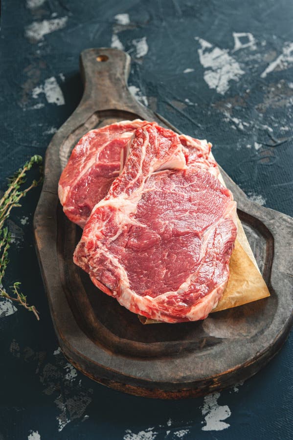 A Meat Cutlet on a Wooden Background is Ready for Grilling Stock Photo ...