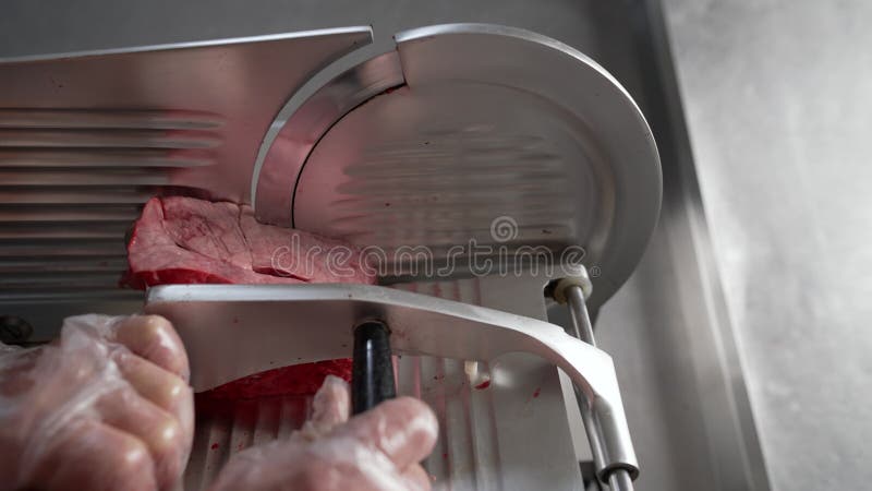 Meat Cutting Slicing Machine in Food Processing Factory. Meat is Cut on ...