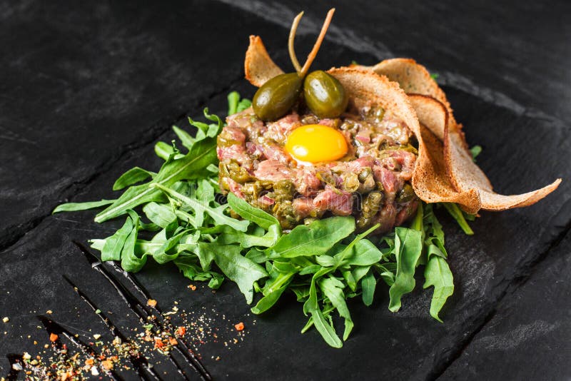 Meat Dish Tar Tar from Beef with Vegetables, Fresh Herbs and Quail Eggs ...