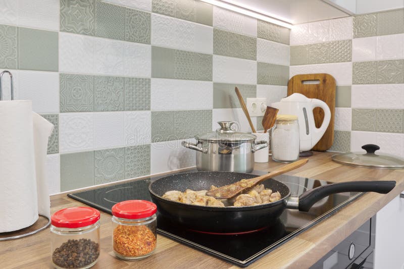 The Meat is Fried in Pan on Hob. Kitchen Interior, Cooking Utensils ...