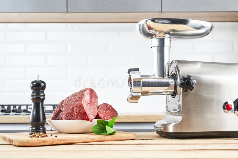 Meat Grinder with Fresh Meat on Wooden Table in Kitchen Interior Stock ...