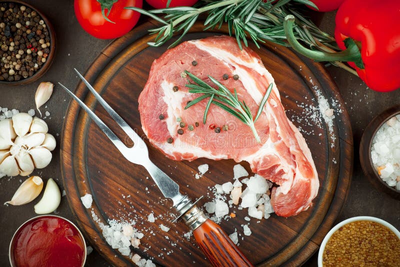 Meat with Kitchen Accessories on an Old Background. Stock Photo - Image ...