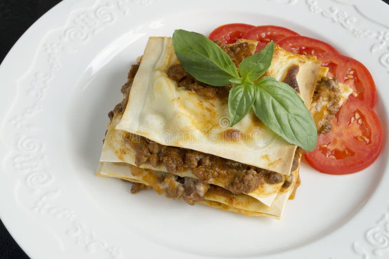 Meat lasagna with basil stock image. Image of cooking - 199788953