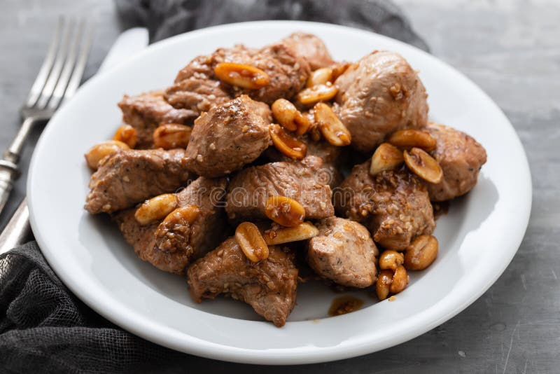 Meat with Nuts on White Plate on Ceramic Background Stock Photo - Image ...
