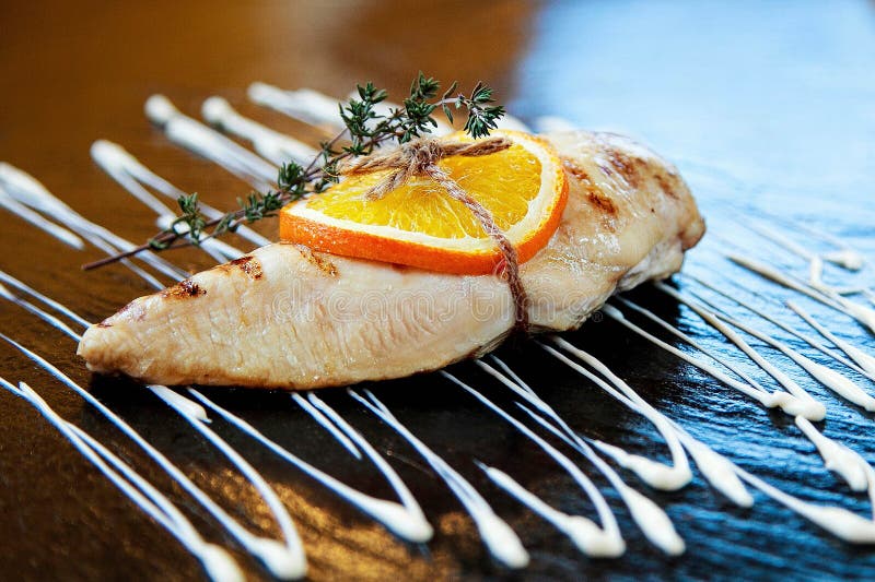 Meat with an Orange Slice on Black Background Stock Photo - Image of ...