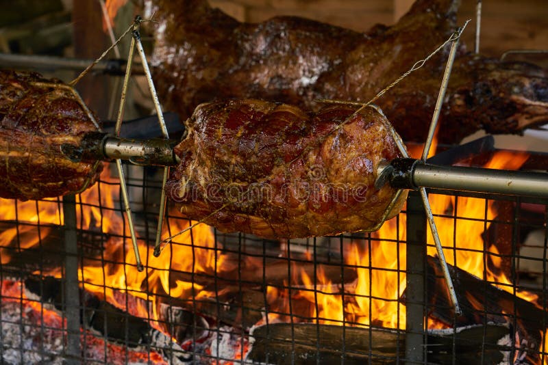 Meat Spit Roasting Over the Flames of a Log Fire Stock Photo - Image of ...
