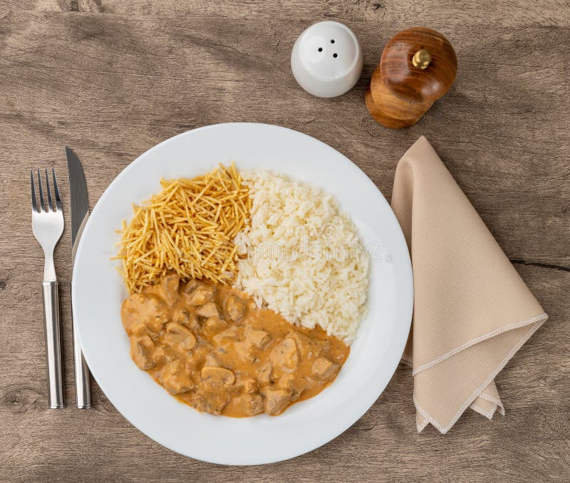 Meat Strogonoff with Rice and Straw Potato Over Wooden Table Stock ...