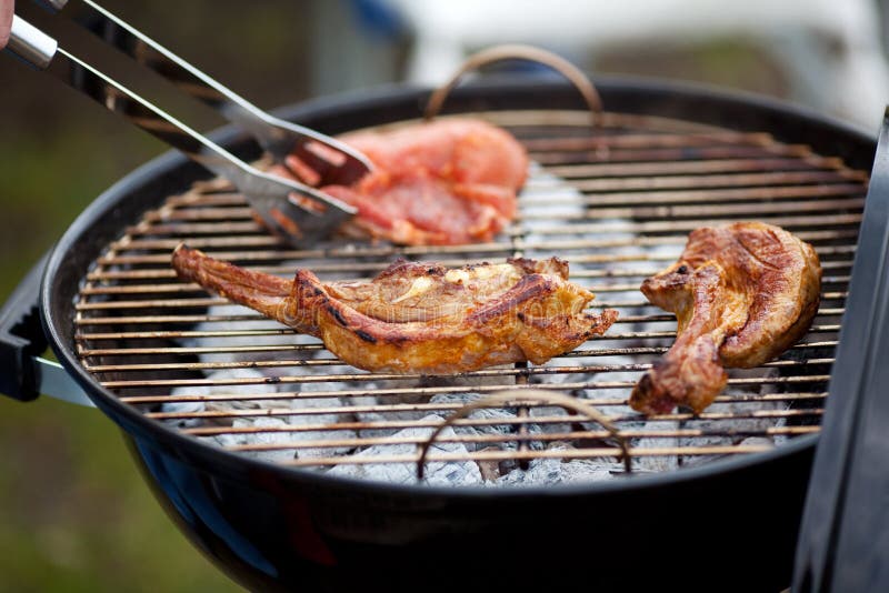 Meat and Tongs on Barbecue stock photo. Image of outdoors - 31261106