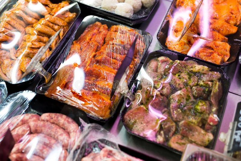 Meats in Marinade on Supermarket Display, Pre-cooked Food. Stock Photo ...