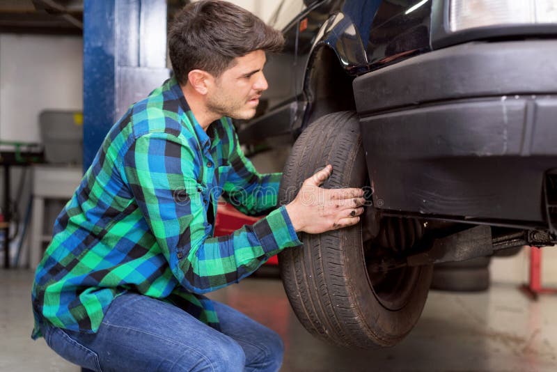 Mecanic Checking Car Suspension System, at Repair Service Station ...