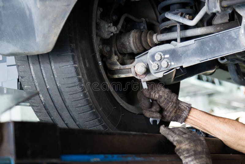Mechanic Adjusting the Chamber Area during Wheel Alignment Process ...