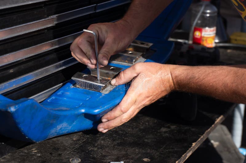 A Mechanic Fixes a Bumper on a Racing Car Stock Image - Image of male ...