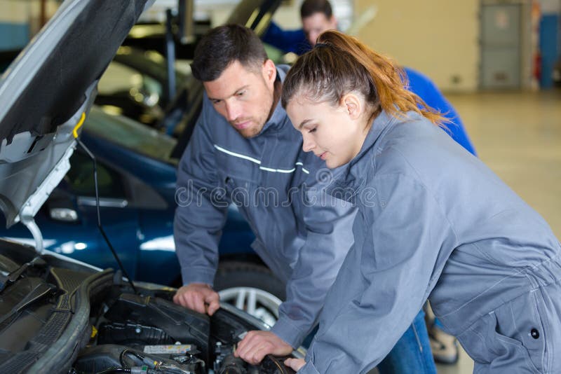 Mechanic and Apprentice Looking at Cars Engine Stock Photo - Image of ...