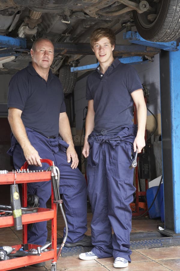 Mechanic and Apprentice Working on Car Stock Photo - Image of skill ...