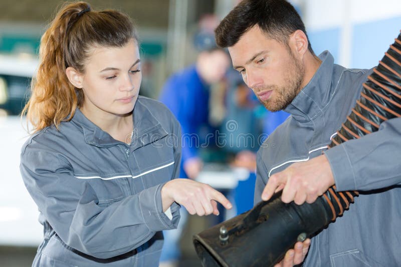 Mechanic and Apprentice Working on Car Part Stock Image - Image of ...