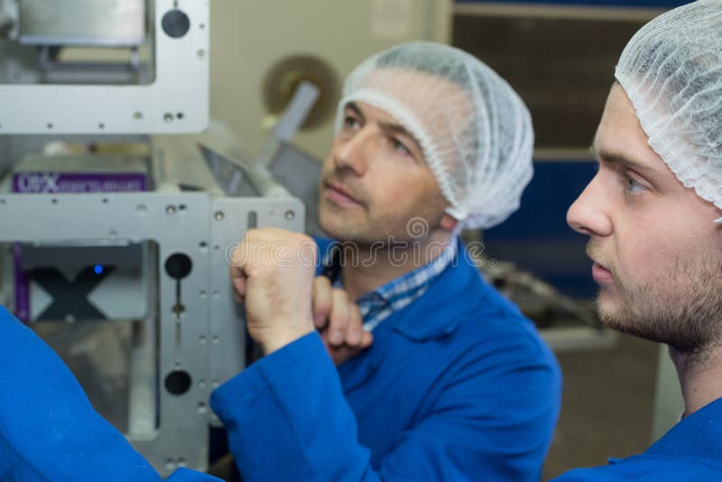 Mechanic and Apprentice Working in Factory Stock Image - Image of ...
