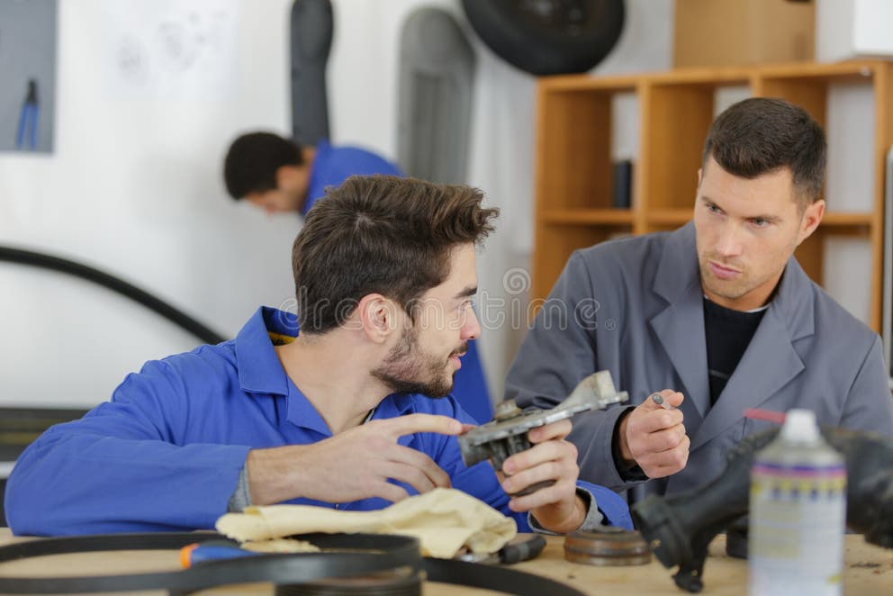 Mechanic Assembler Having Conversation Stock Image - Image of teacher, work: 100305431