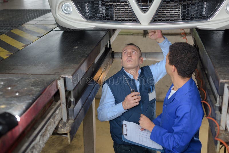 Mechanic and Assistant Checking Car Stock Image - Image of engine ...